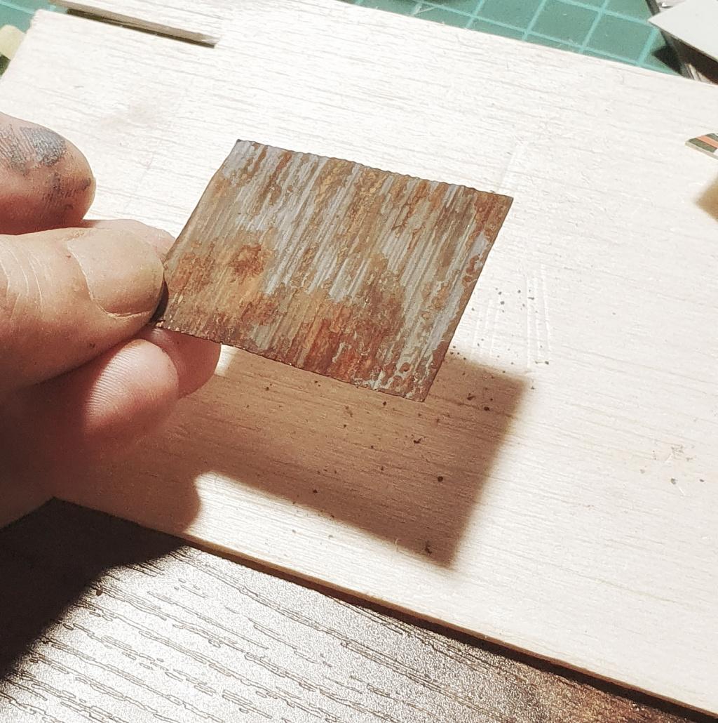 One nearly completed painted and weathered model corrugated roof panel.